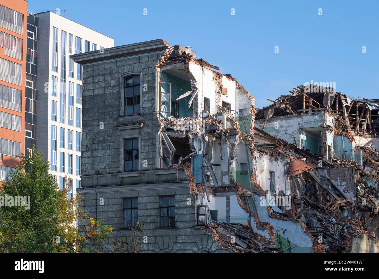 Old collapsed building against the background of new multi-storey ...
