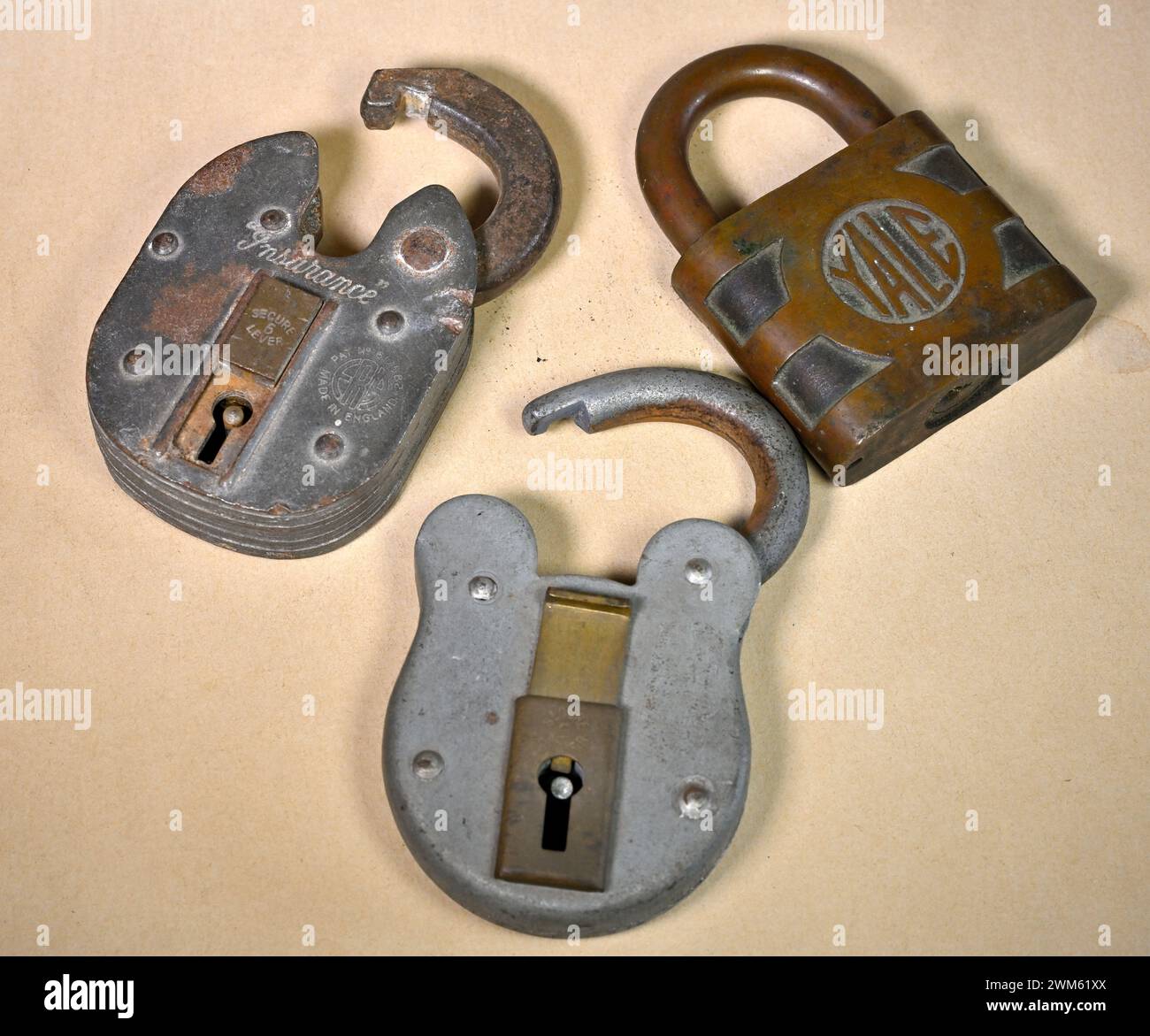 Three padlocks, two unlocked, one locked Stock Photo - Alamy