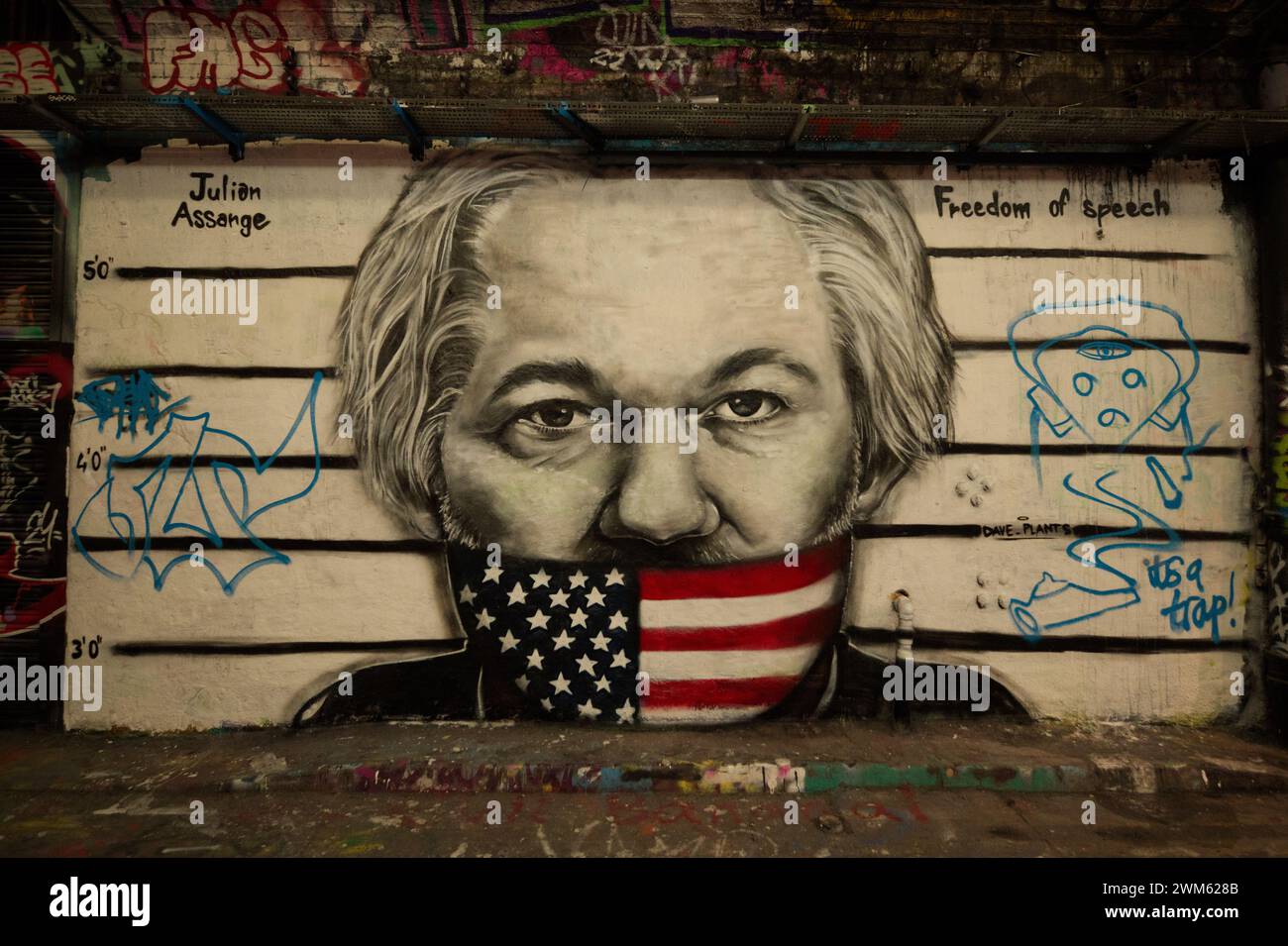Graffiti artwork of Julian Assange gagged by a US flag in Leake Street ...