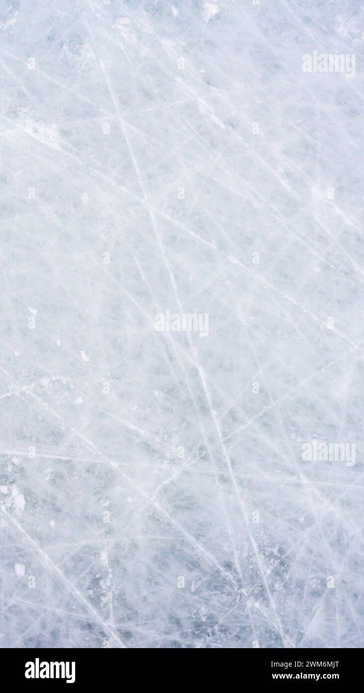 Ice background with marks from skating and hockey, blue texture of rink ...