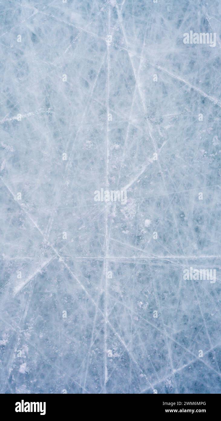 Ice background with marks from skating and hockey, blue texture of rink ...