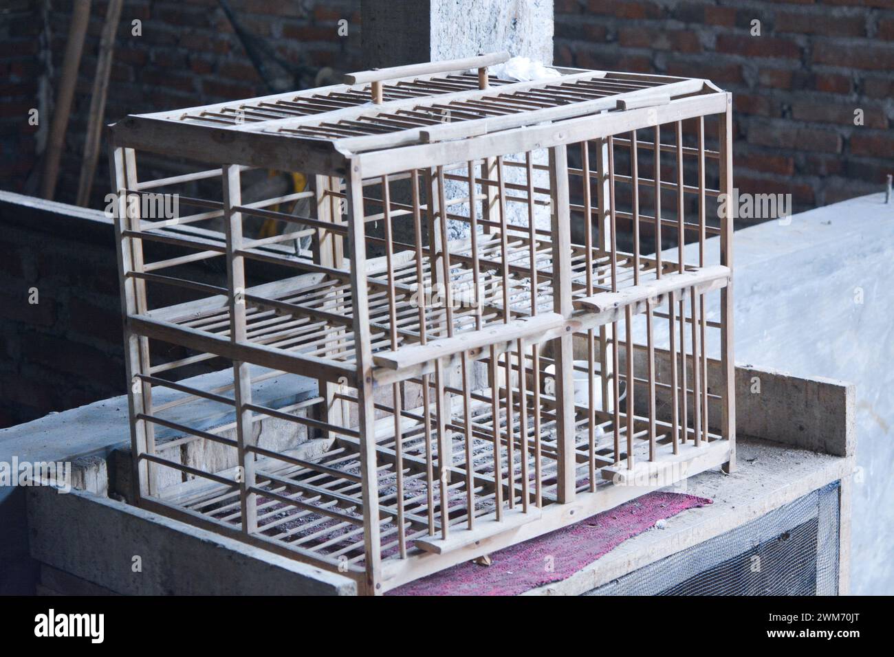 Red birdcage with open door. with a rural setting. low angle Stock ...