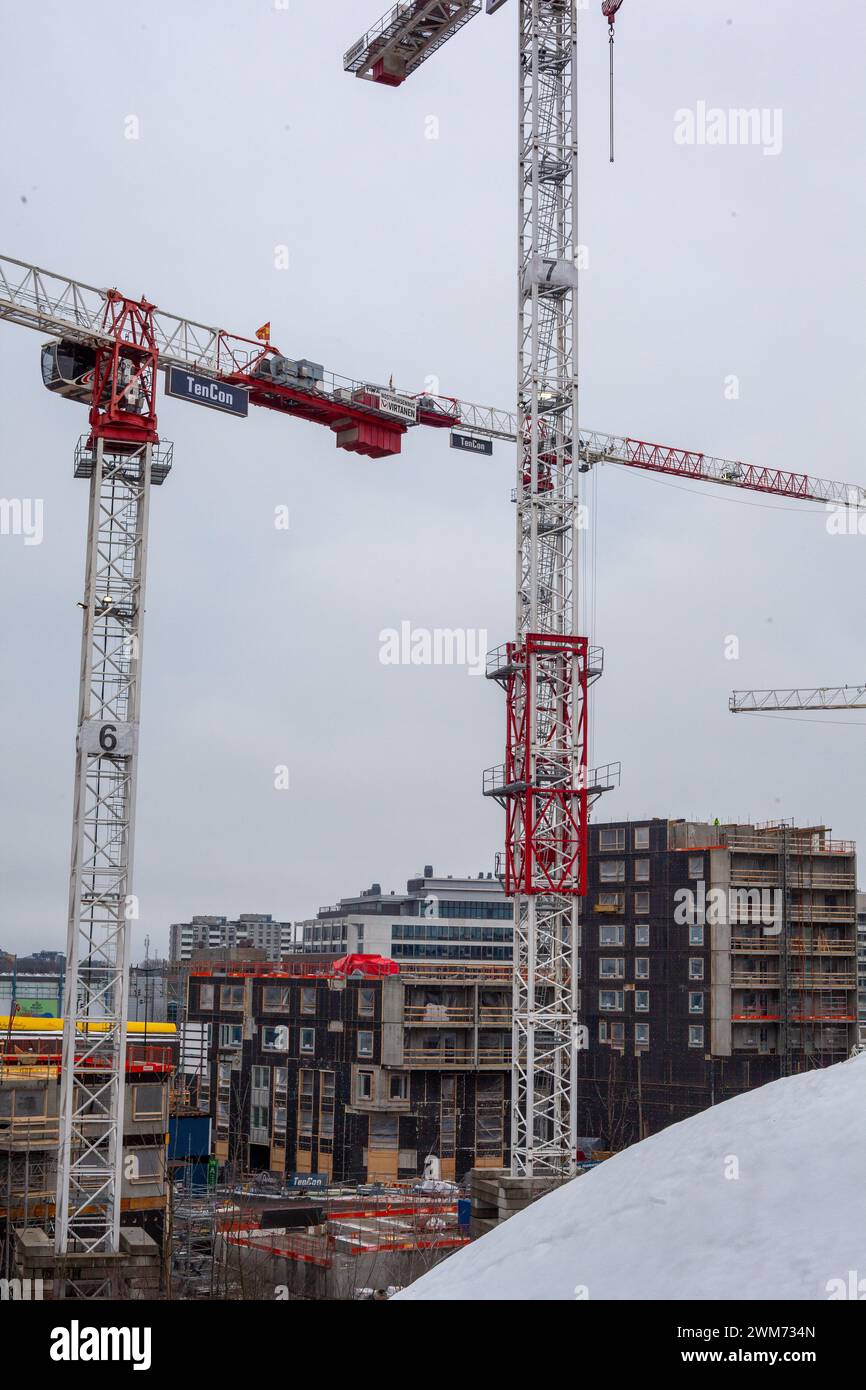 : A busy construction site in Pasila with towering cranes, unfinished ...