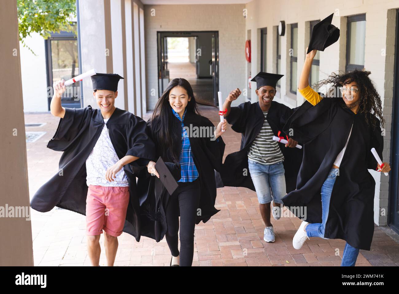 Diverse group of graduates celebrates outdoors, with copy space Stock ...
