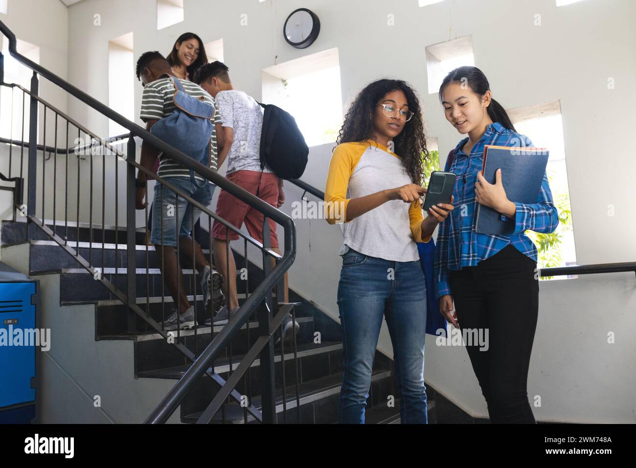 Diverse students gather in a high school stairwell Stock Photo - Alamy