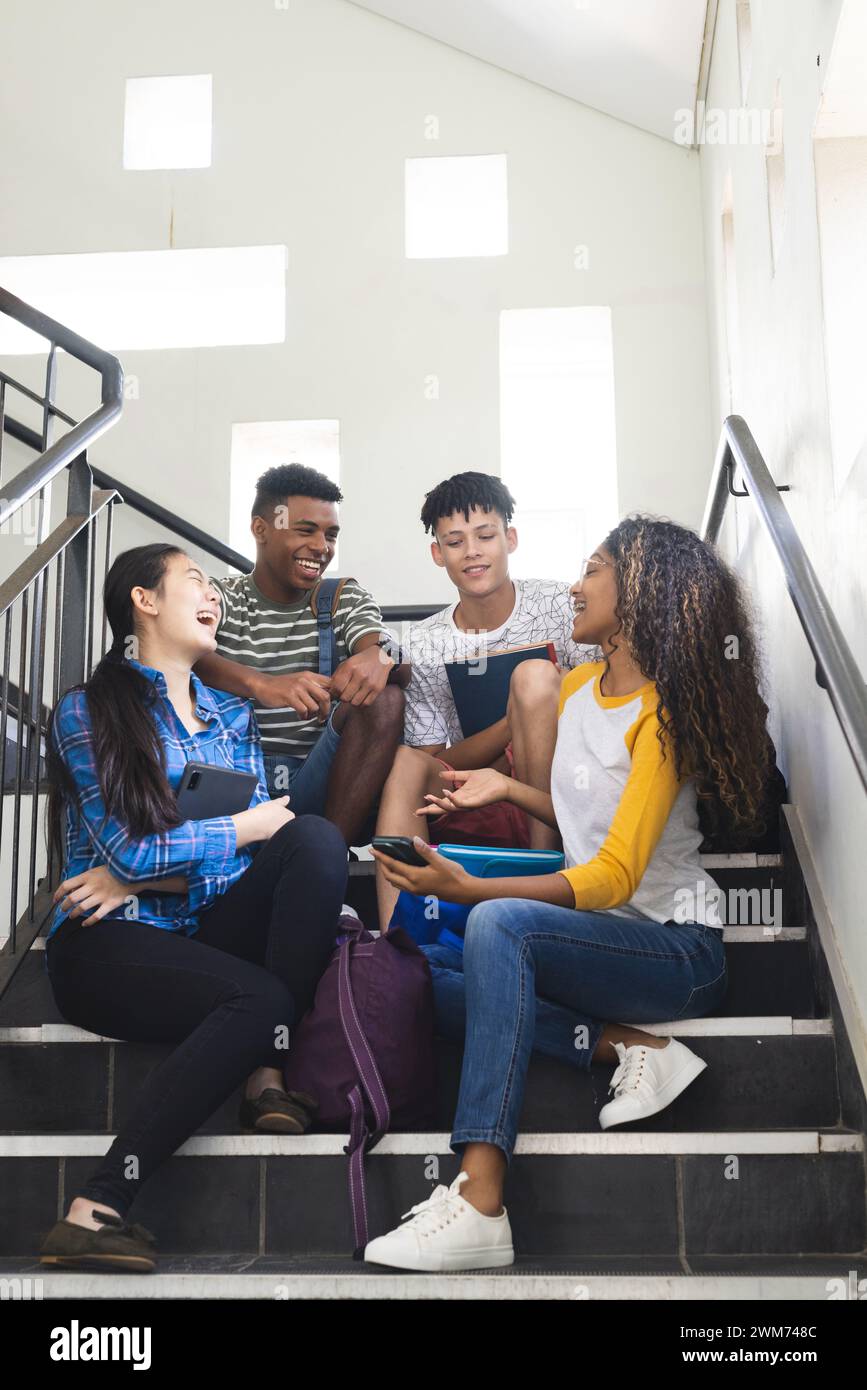 Teenage biracial boys and a teenage girl chat on high school stairs Stock Photo - Alamy
