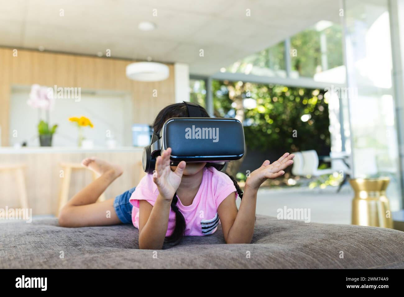Biracial girl explores virtual reality at home Stock Photo - Alamy