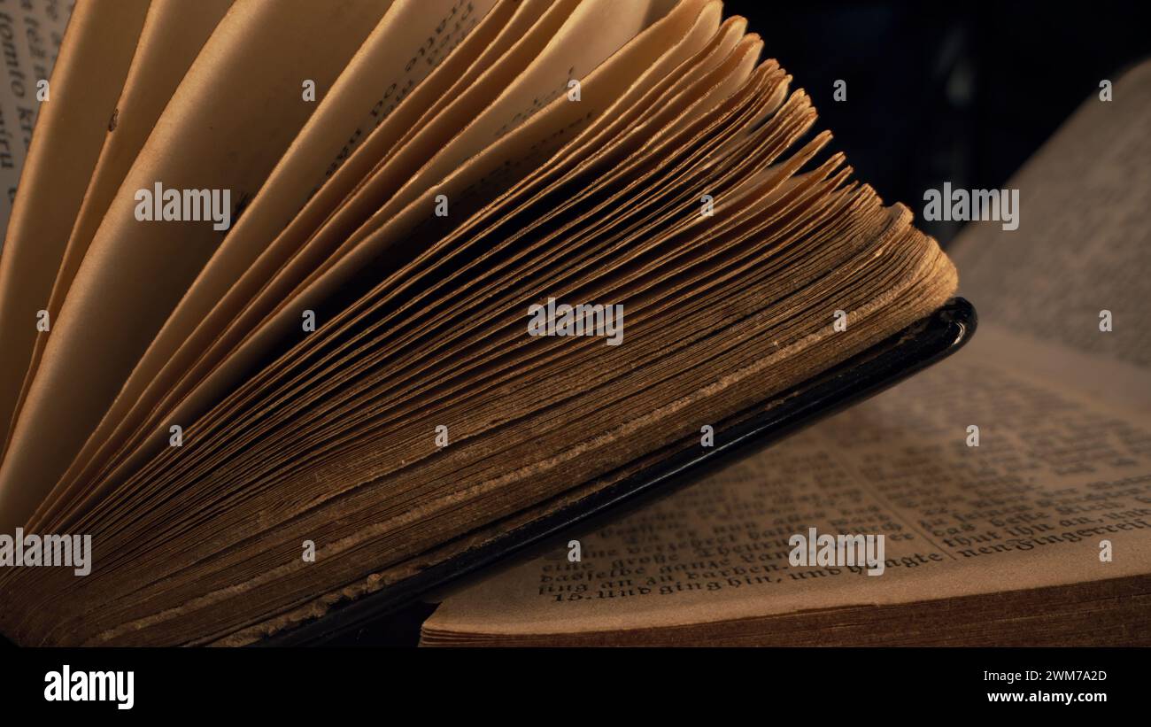 Opened saved medieval book with ancient writings. Religious literature ...