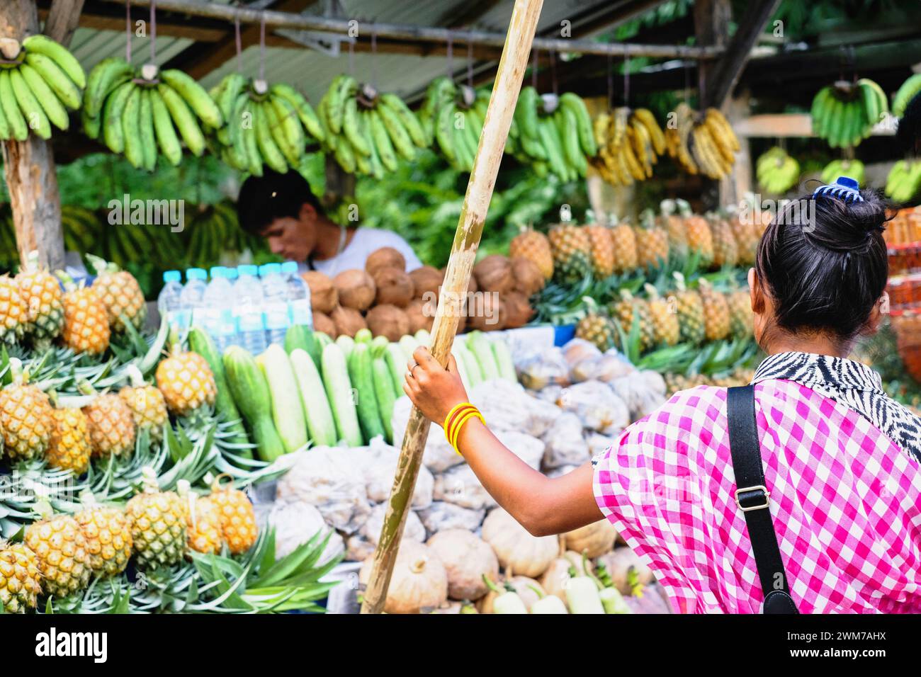 A Street market and vegetable and fruit sellers at the roadside along ...