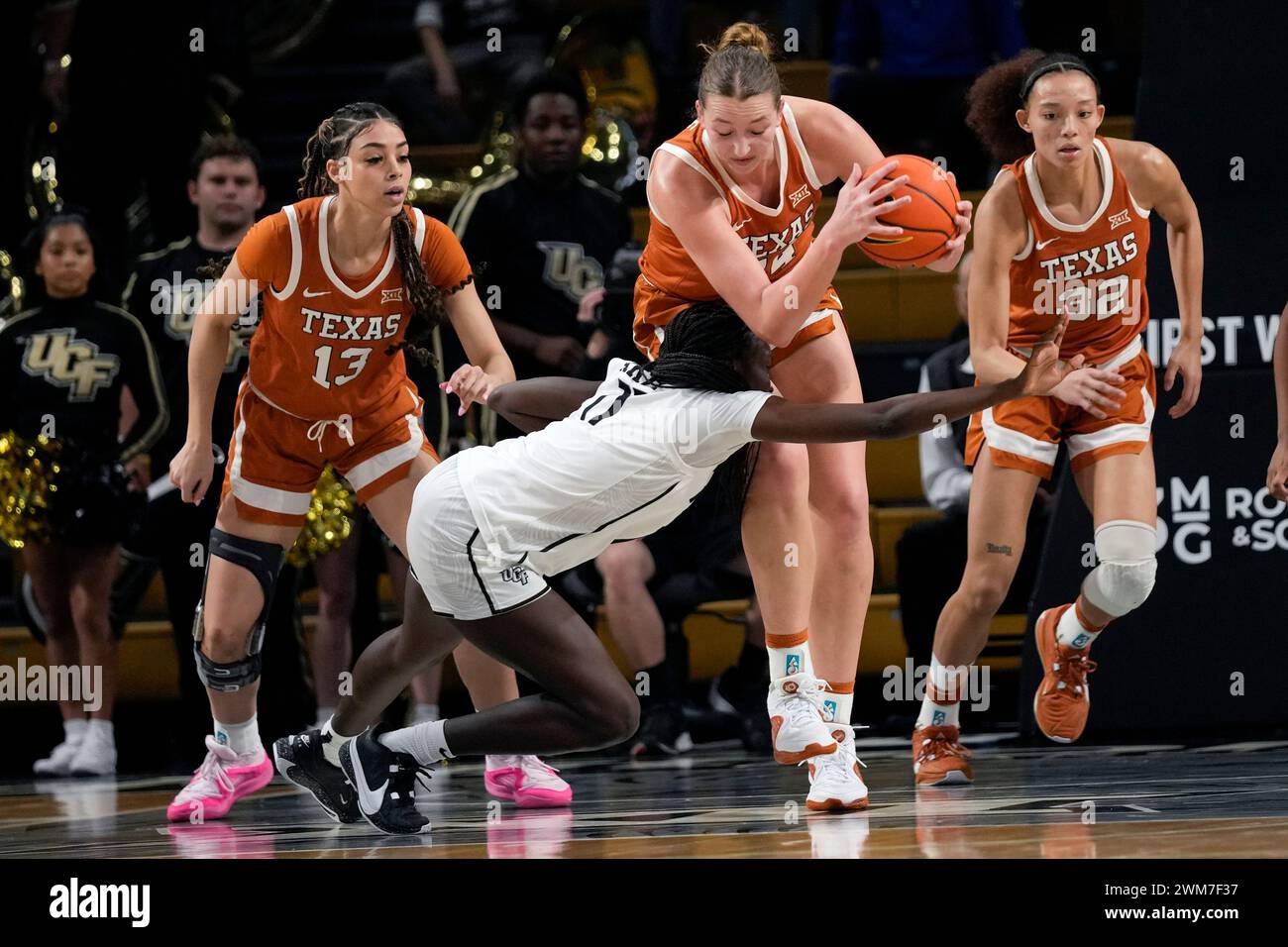 Texas forward Taylor Jones, center, grabs a rebound in front of Central ...