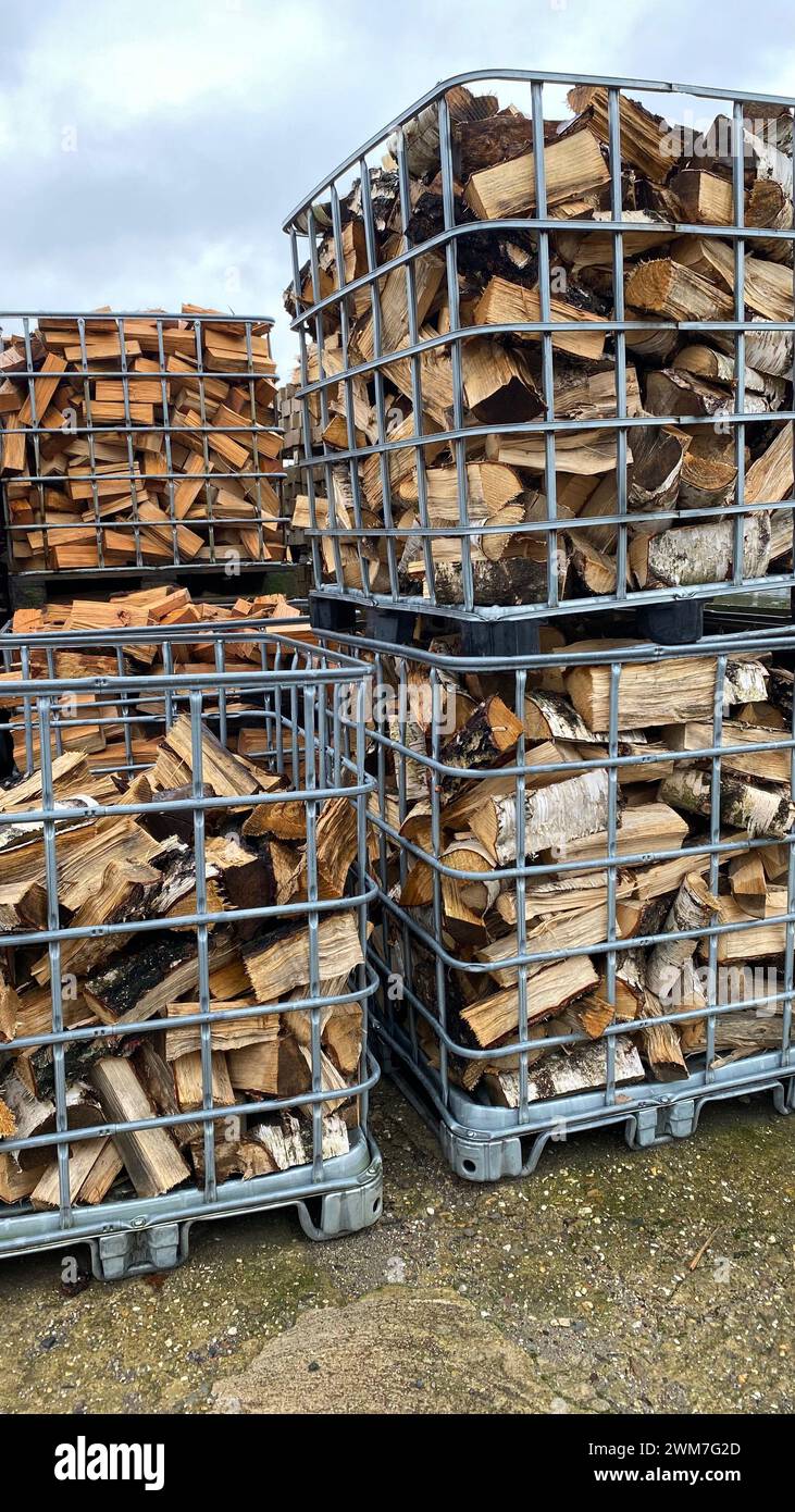 Many Prepared containers with Firewood for sale in storage outside ...