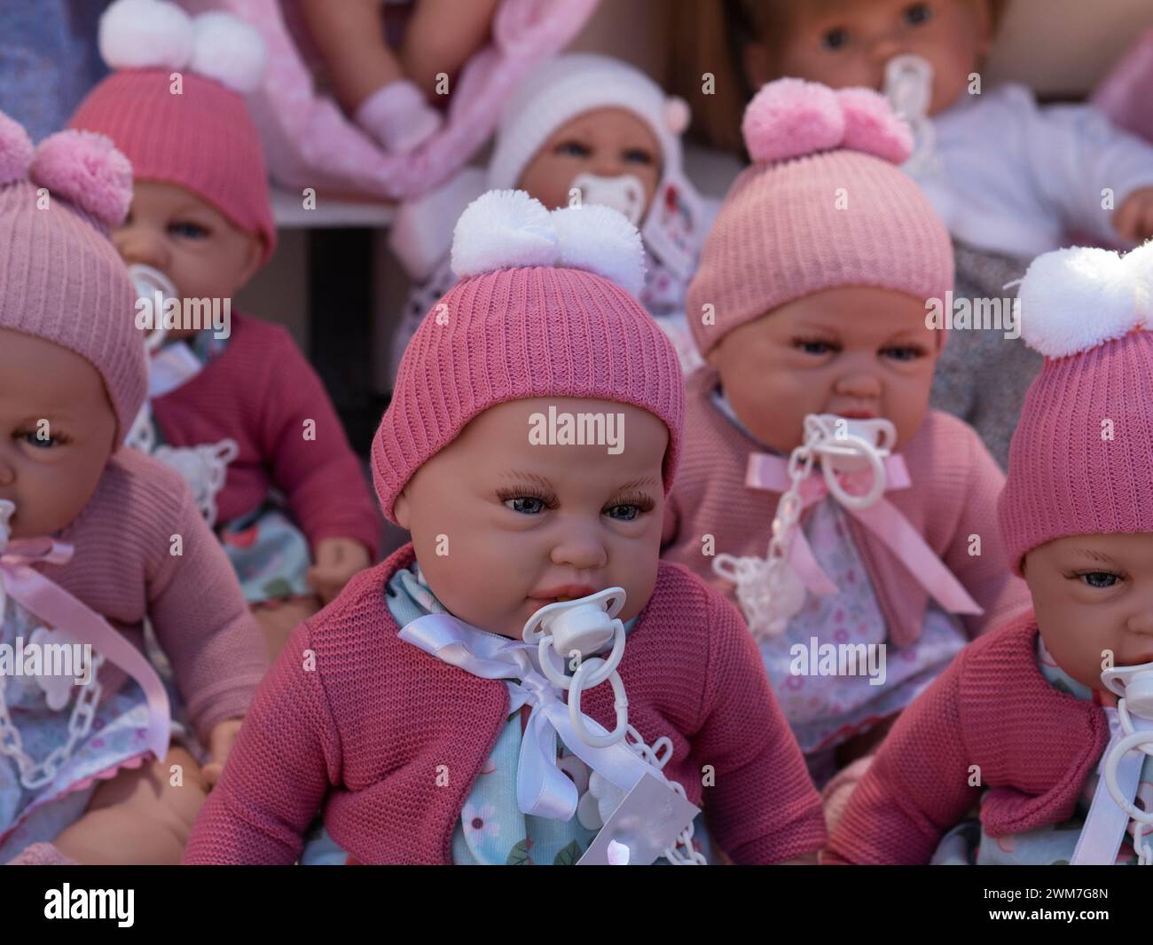 Dolls at a sales stand, all dressed the same Stock Photo - Alamy