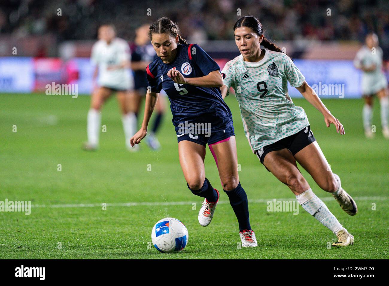 Dominican Republic defender Nadia Colon (5) is defended by Mexico ...