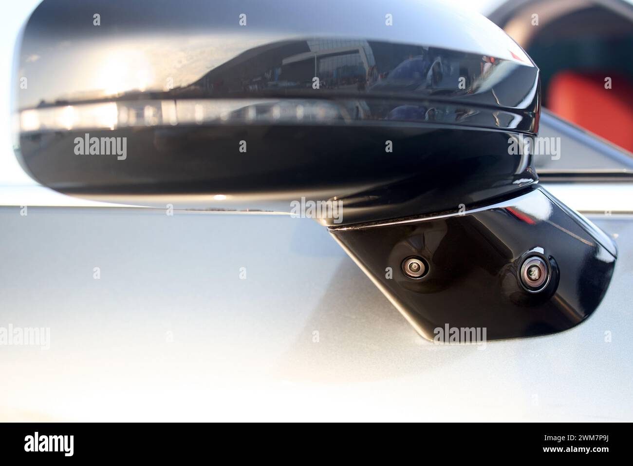 Luxury car detail right back mirror two parking cameras closeup. Road ...