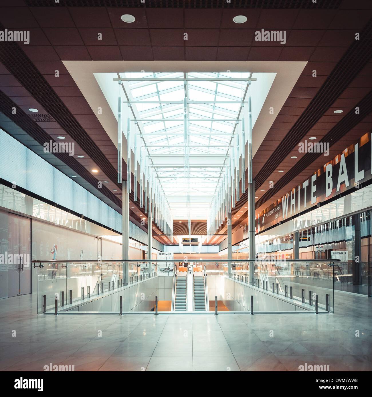 empty shopping mall. Symmetric perspective view of upper floor filled ...