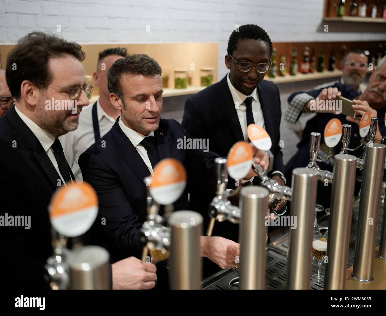 French President Emmanuel Macron topped a glass of beer as he visits ...