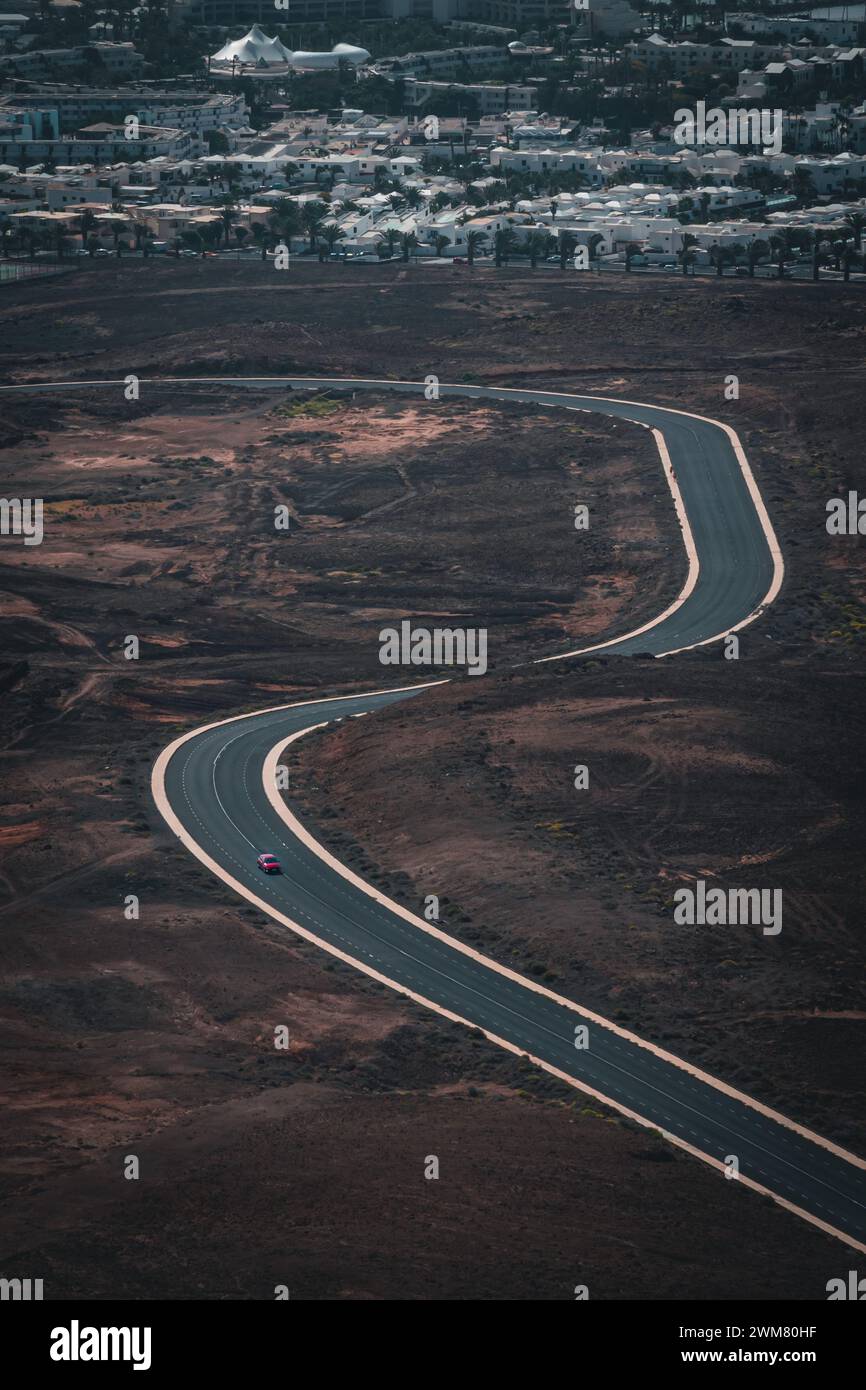 View from above on the single red car driving on the AZ-14 road near ...