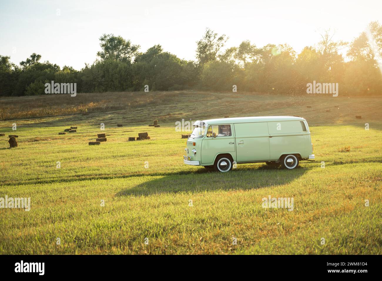 Green classic Volkswagen Transporter van on countryside unpaved road ...