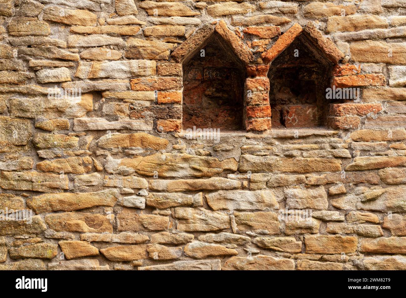 Old stone wall with two windows. Background texture. Close-up Stock ...