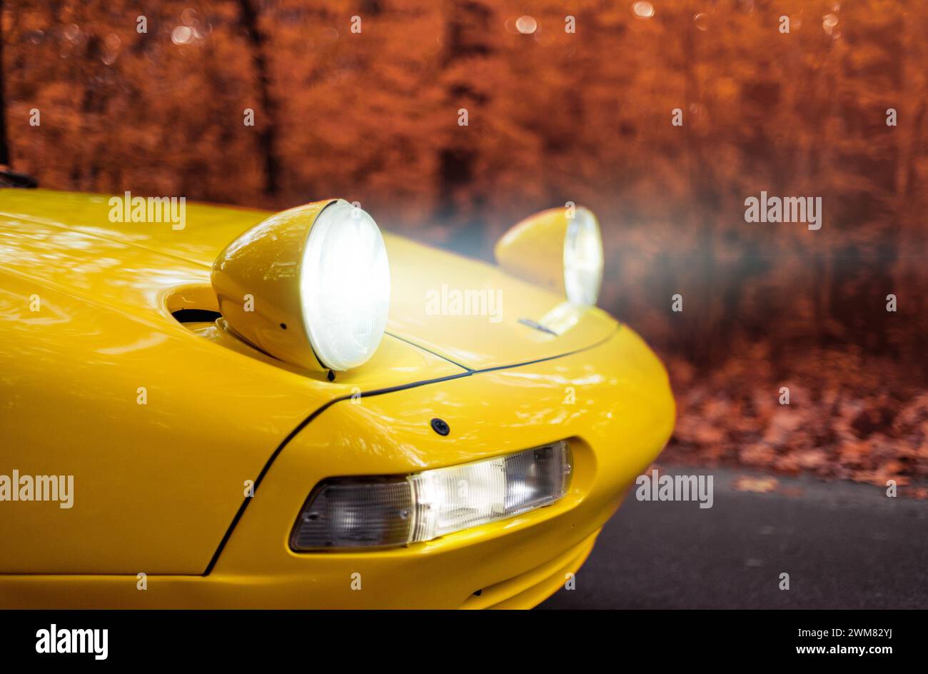 yellow Porsche 928 in autumn forest. 1980s german sportscar in ...