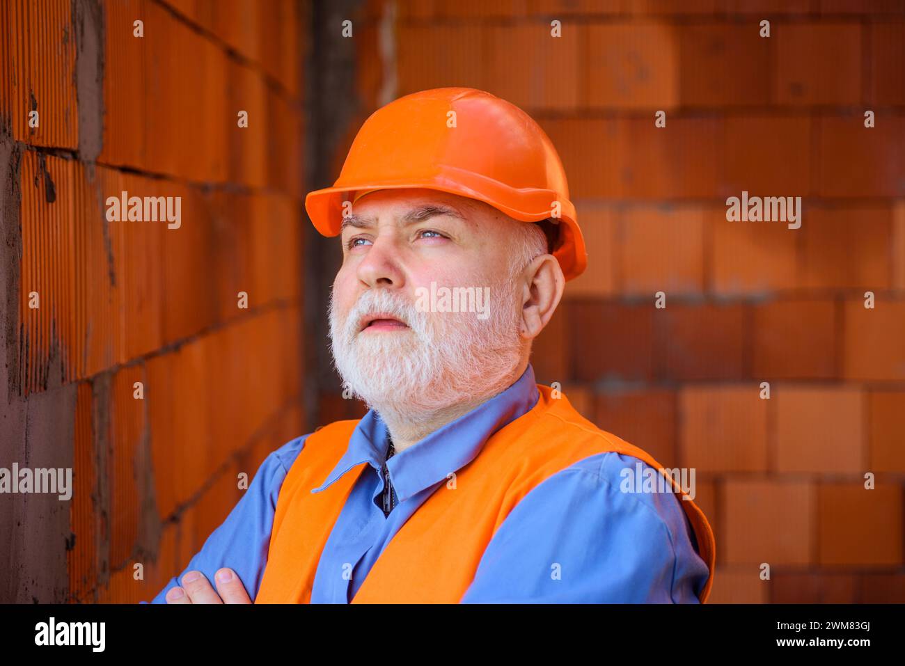 Portrait of construction worker in safety vest and hard hat at work ...