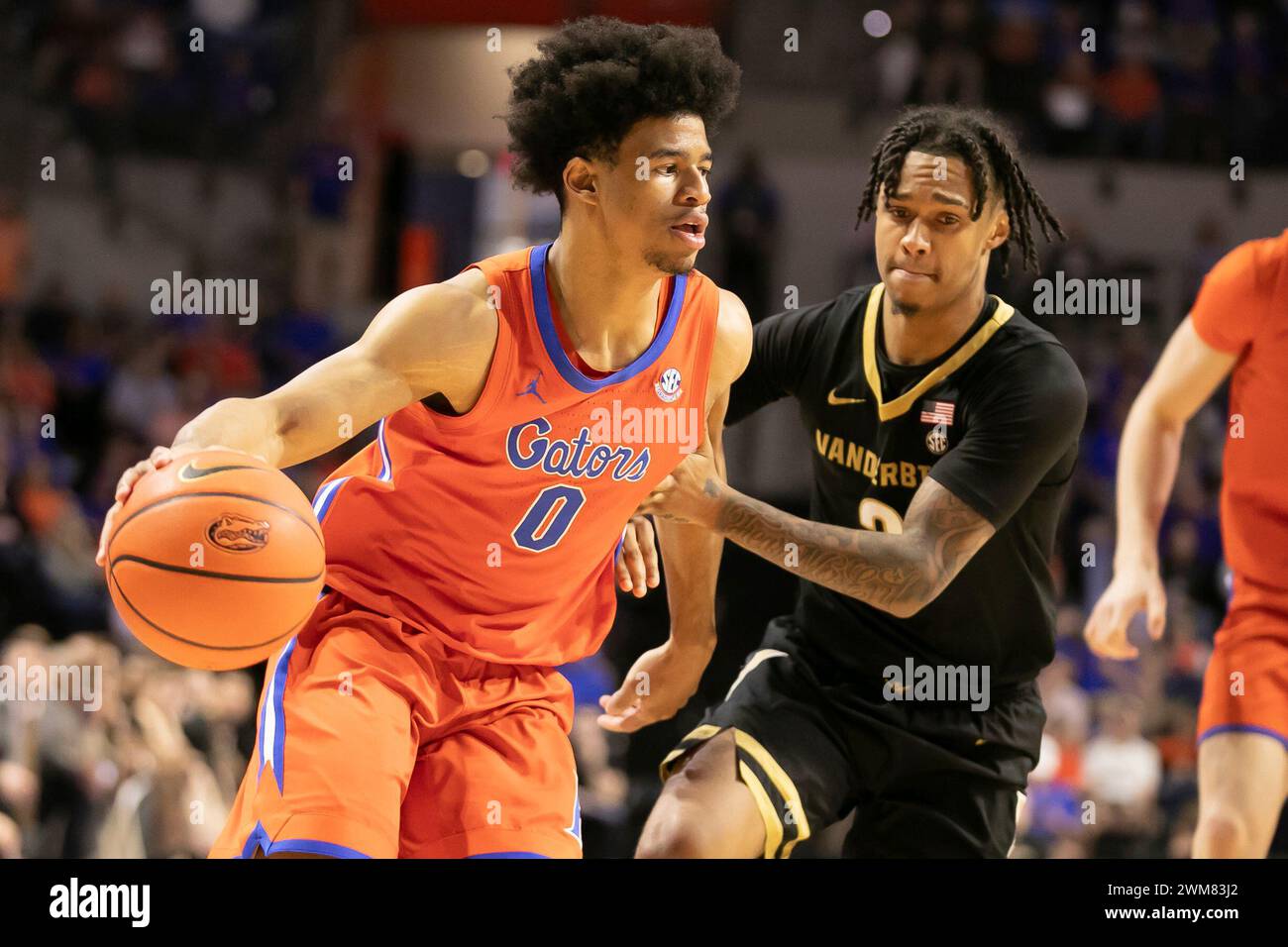 Florida guard Zyon Pullin (0) drives past Vanderbilt guard Paul Lewis, right, during the second ...