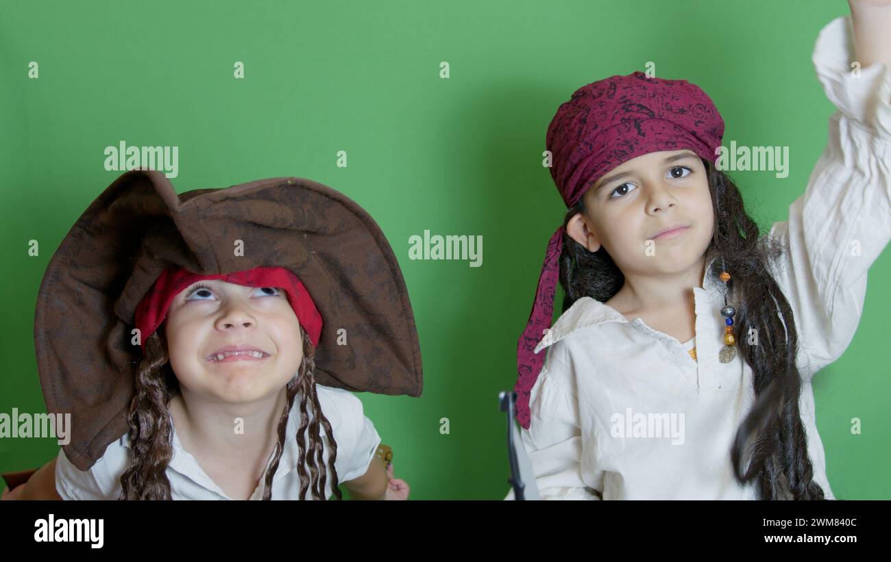 Cute children playing pirates. preschool boy making funny face ...