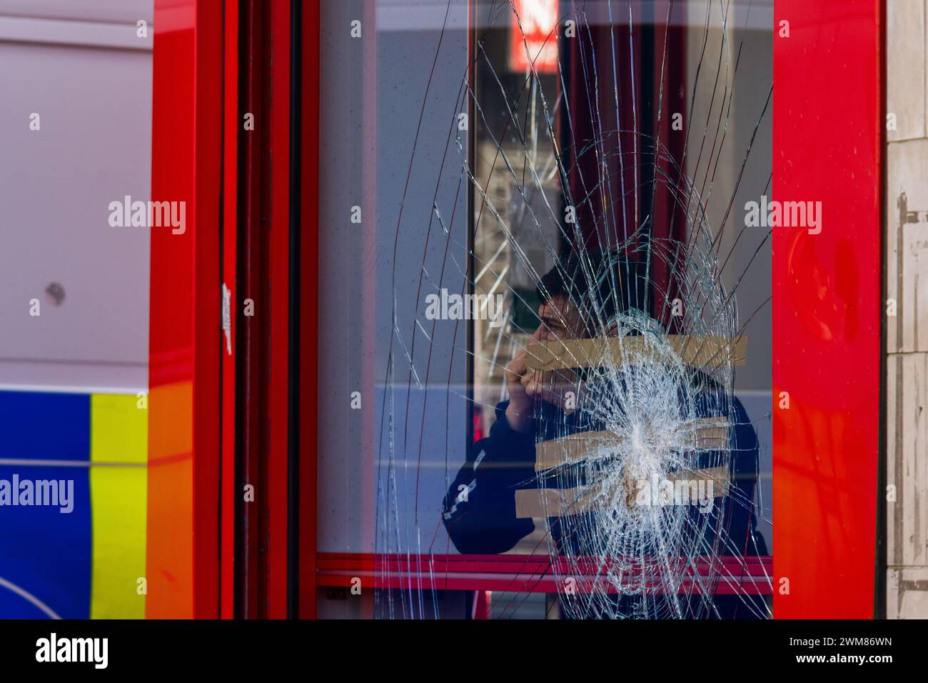 Bradford, UK. 24 FEB, 2024. A Customer looks out from Salah's takeaway ...