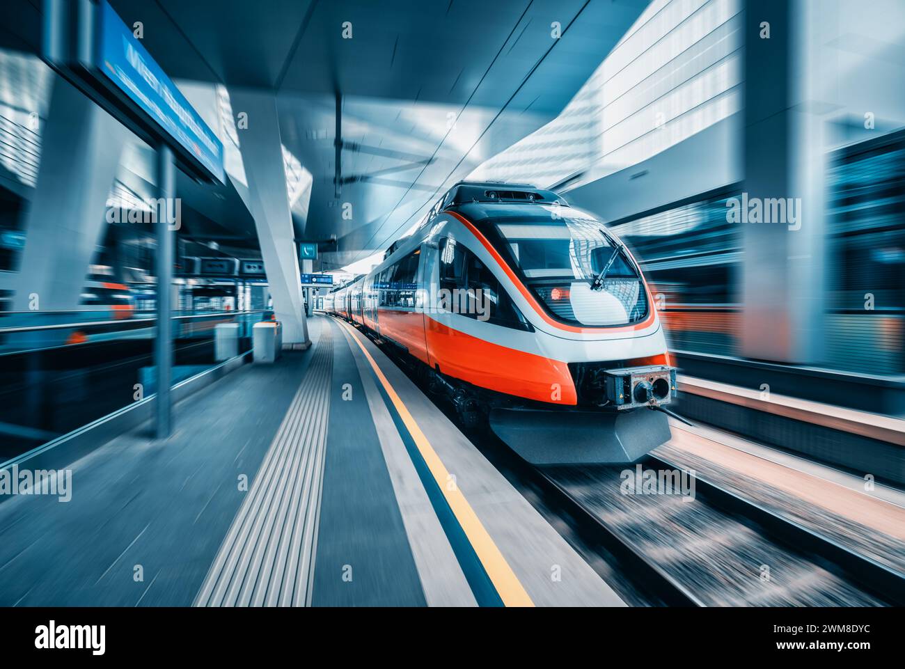 High speed train in motion at modern railway station Stock Photo - Alamy