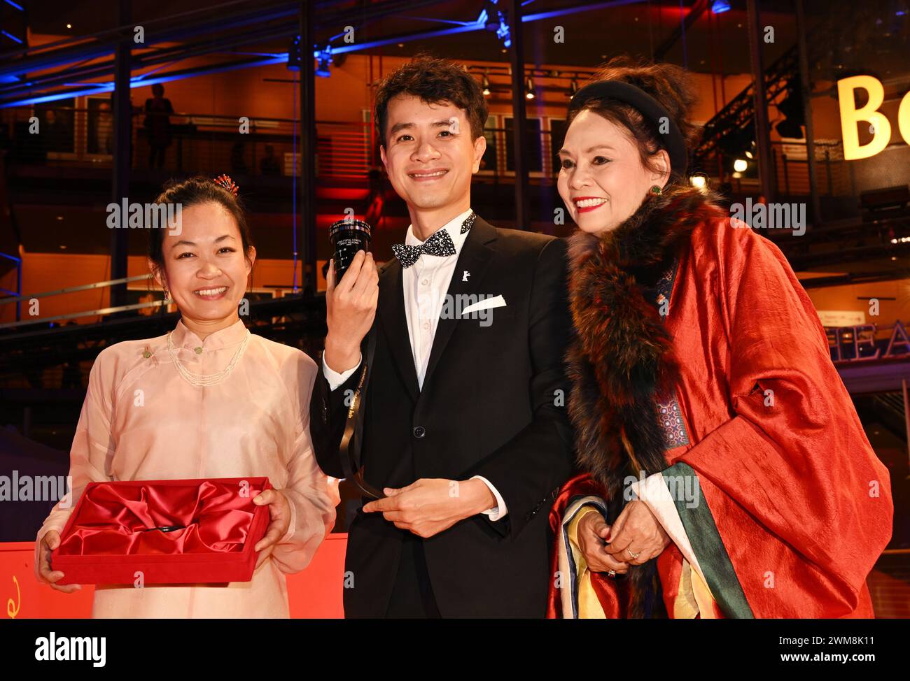 Berlin, Germany. 24th Feb, 2024. Pham Ngoc Lan (M) stands in front of the Berlinale Palast with ...