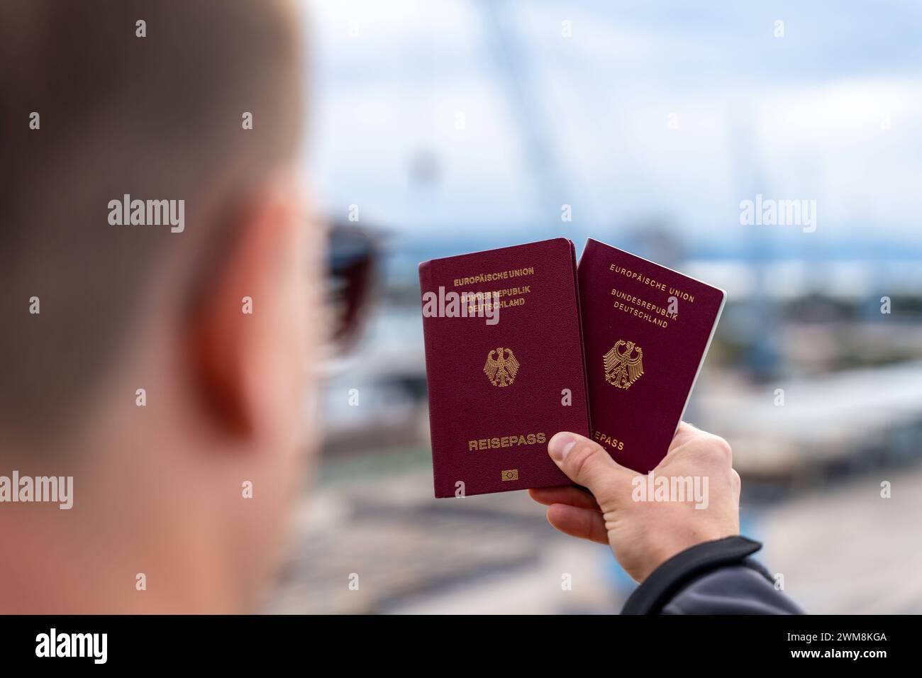 Italy - September 23, 2023: Man holding two German passports. Passport ...