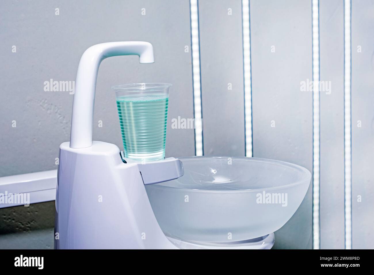 glass of liquid for rinsing teeth in a dental office. dental treatment ...