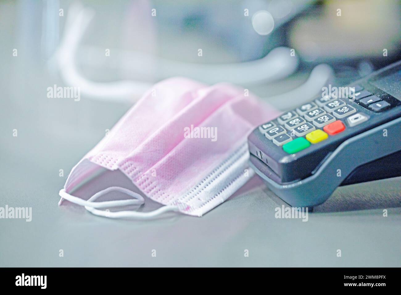 pink medical mask near the calculator. Covid and protection Stock Photo ...