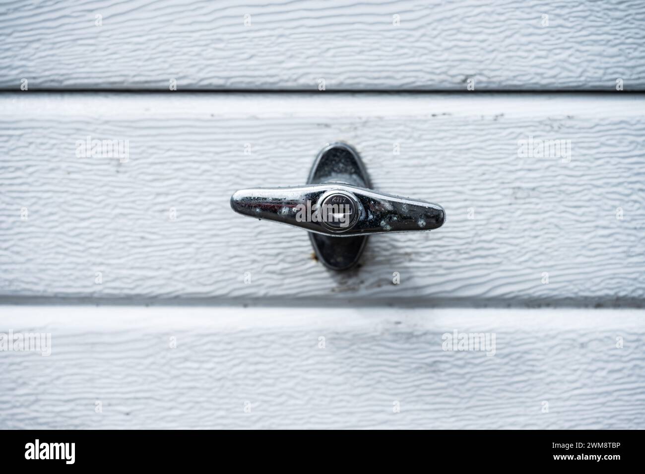 Shiny metal garage door handle Stock Photo - Alamy