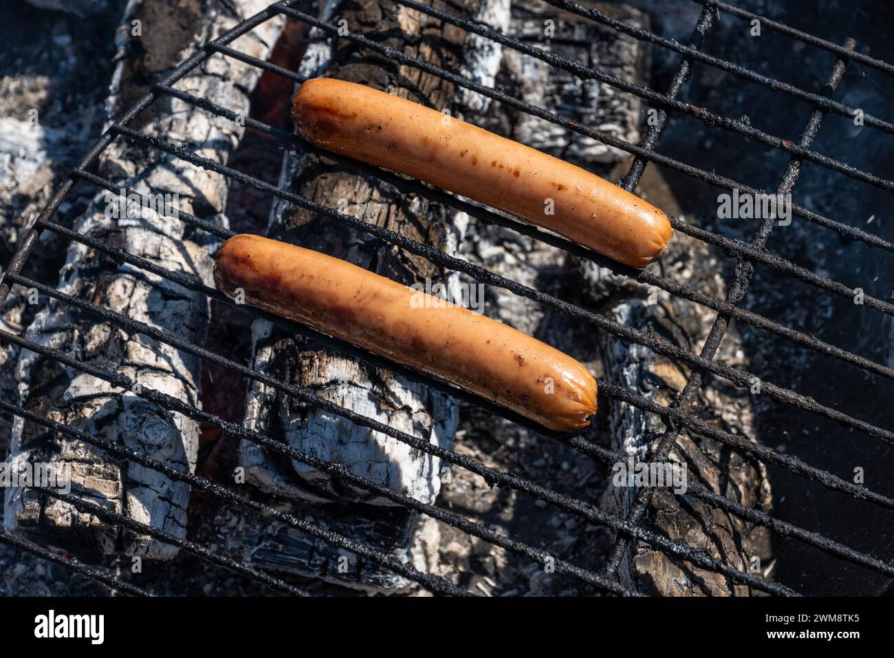 Two hot dogs on a barbecue Stock Photo - Alamy