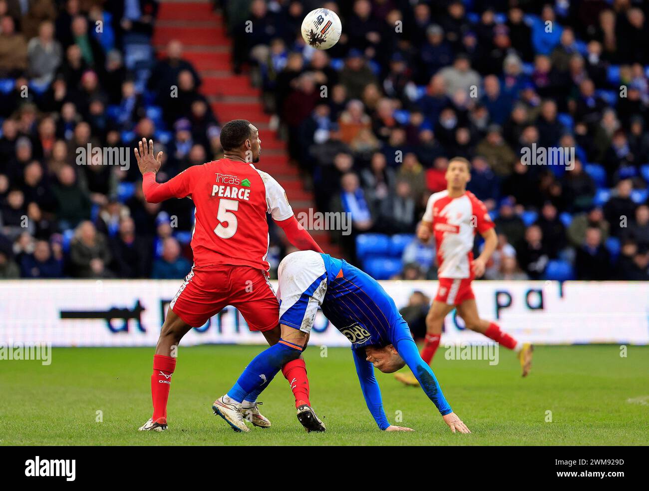 Joe Garner of Oldham Athletic Association Football Club is tussling ...