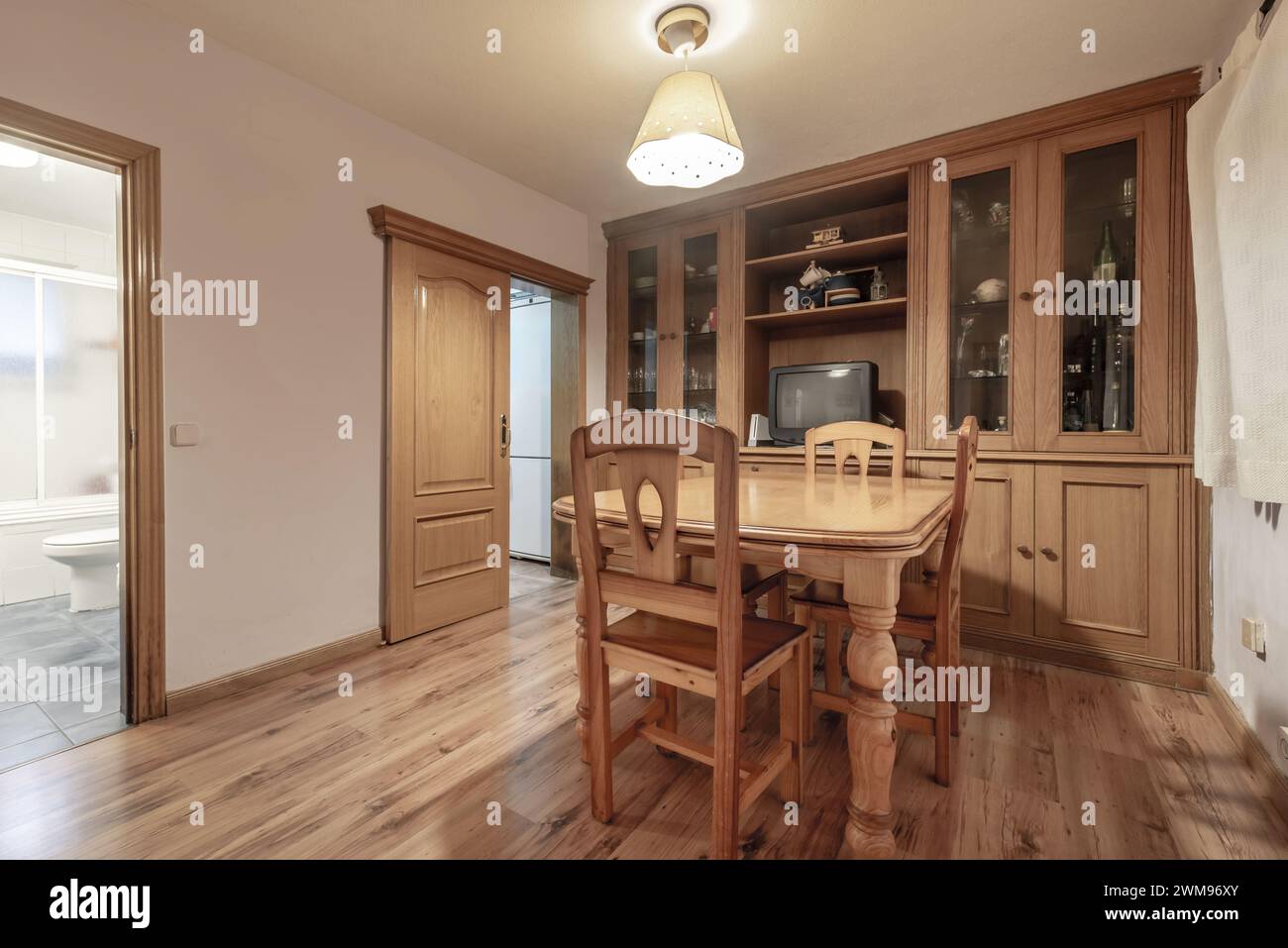 A living room with a custom wooden sideboard on one wall, chestnut wood ...