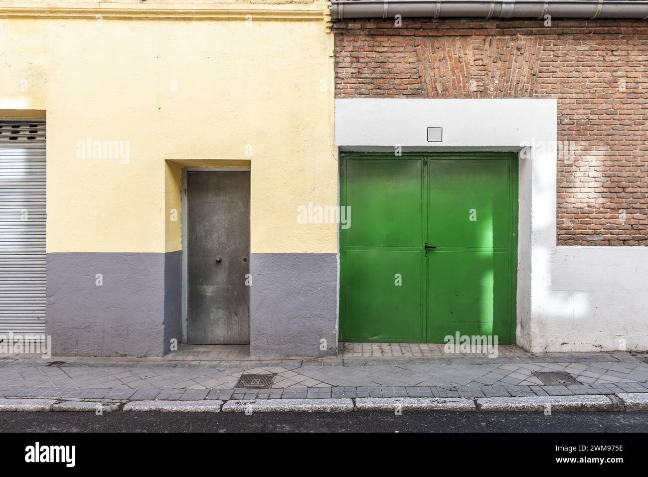 Gray access doors and a larger green one to a ground floor premises ...