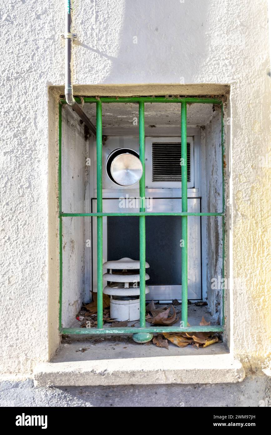A small window with green metal grille and smoke outlets Stock Photo ...