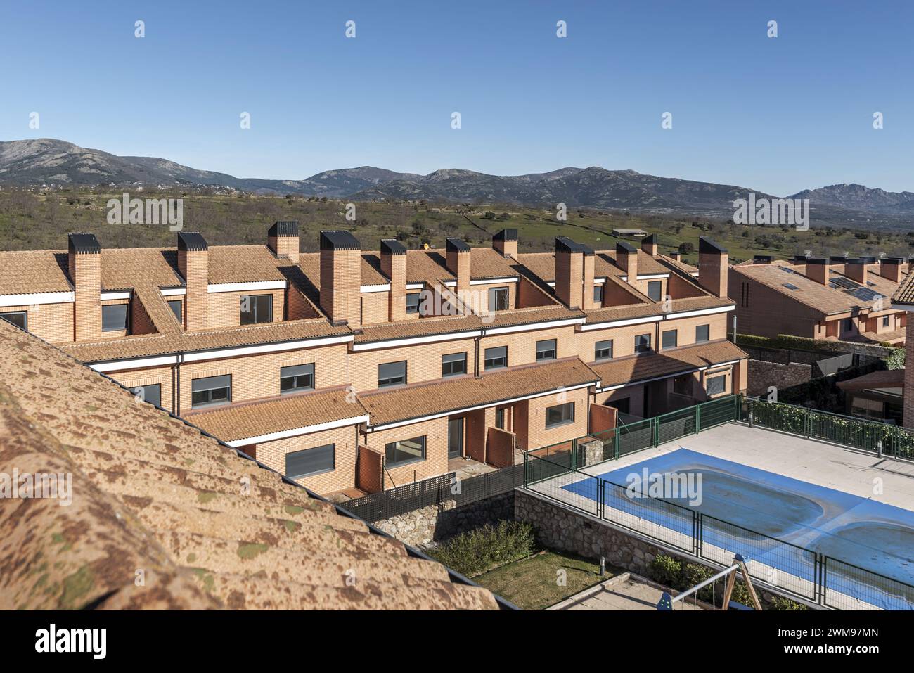 An urbanization of semi-detached single-family homes of various heights ...