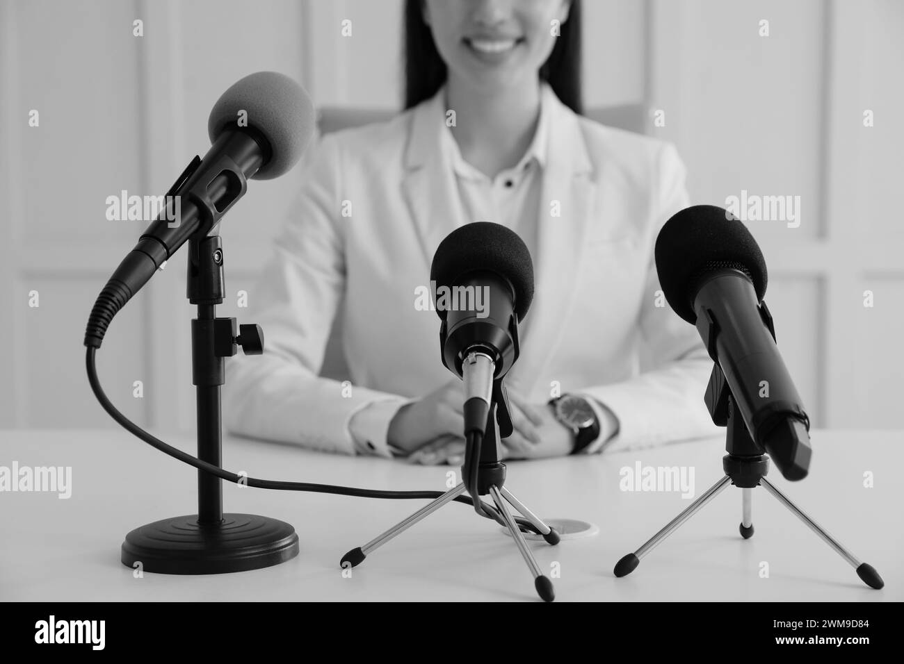 Journalist conference. Businesswoman giving interview at table with ...