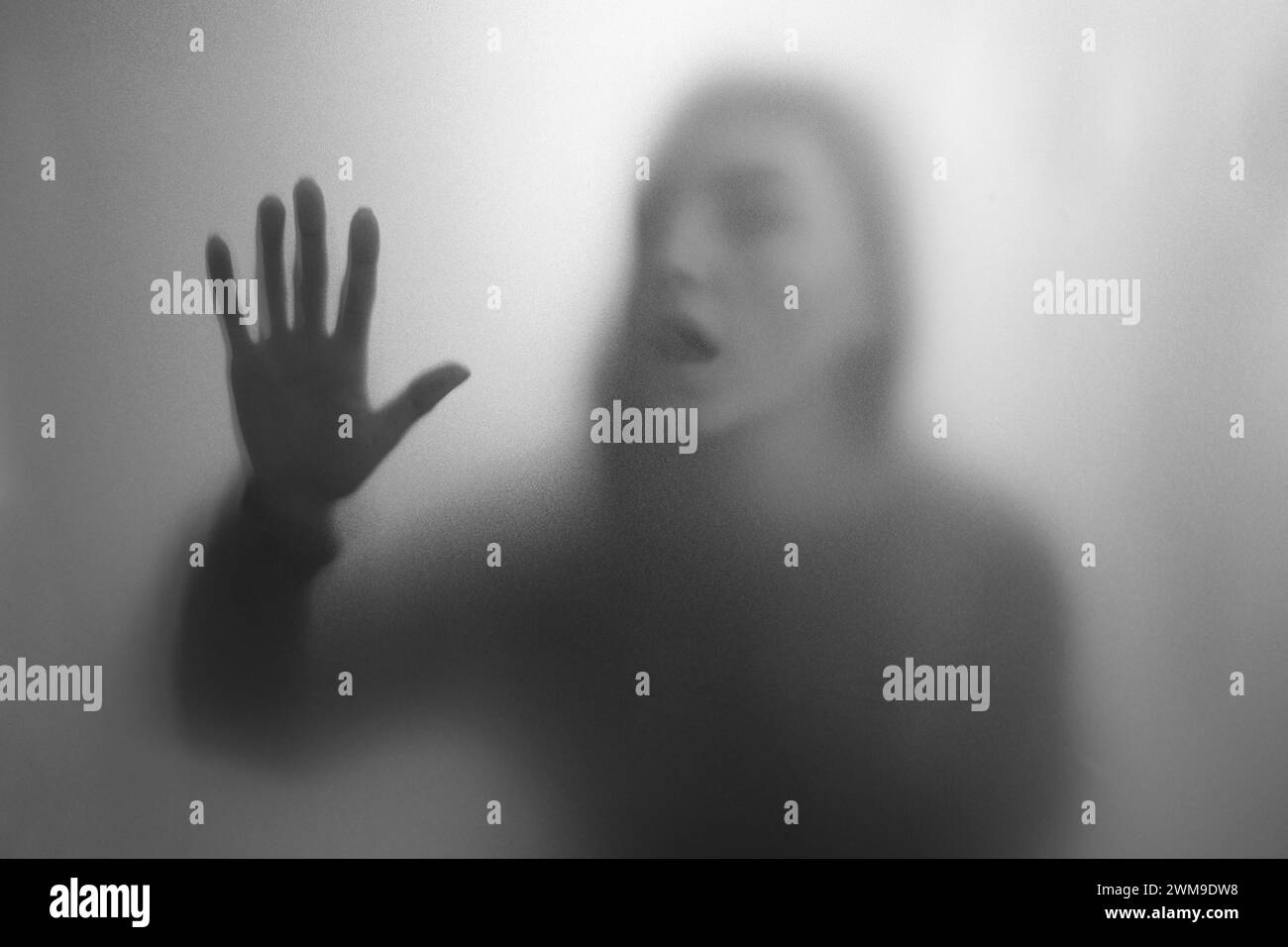 Silhouette of ghost behind fabric against light grey background. Black ...