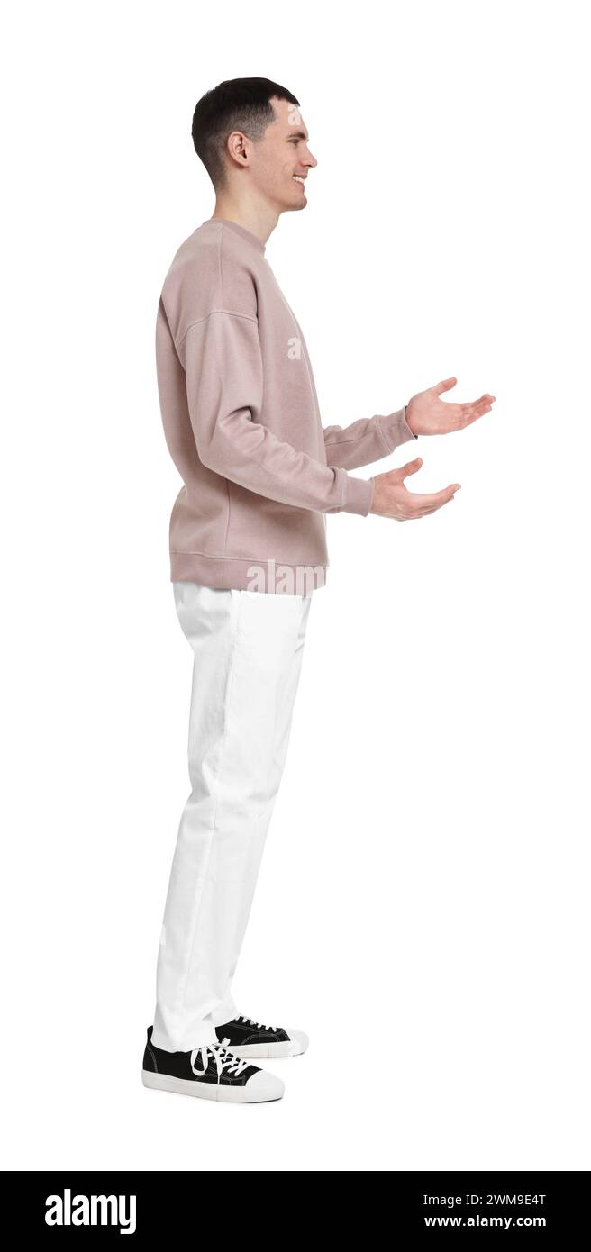 Handsome young man greeting someone on white background Stock Photo - Alamy