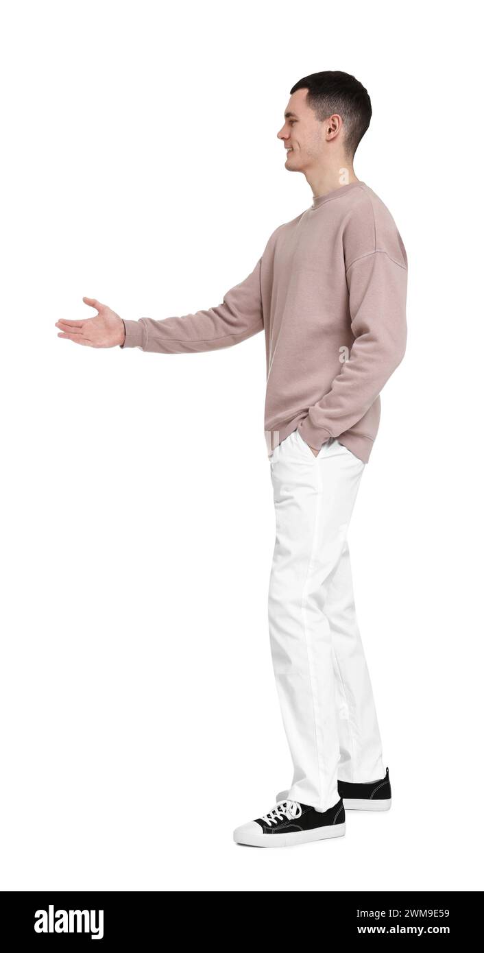 Handsome young man greeting someone on white background Stock Photo - Alamy