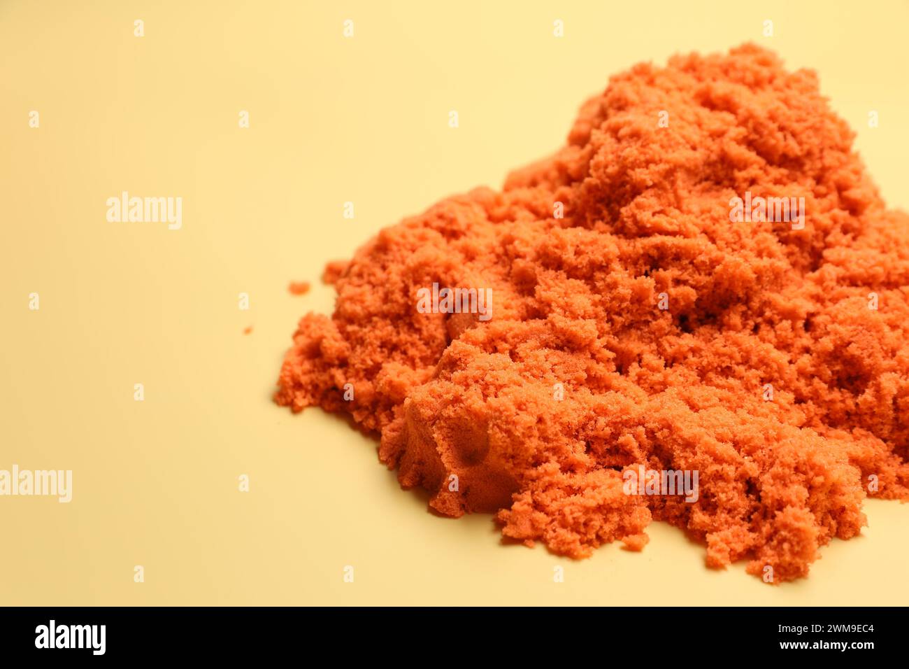 Pile of orange kinetic sand on beige background, space for text Stock ...