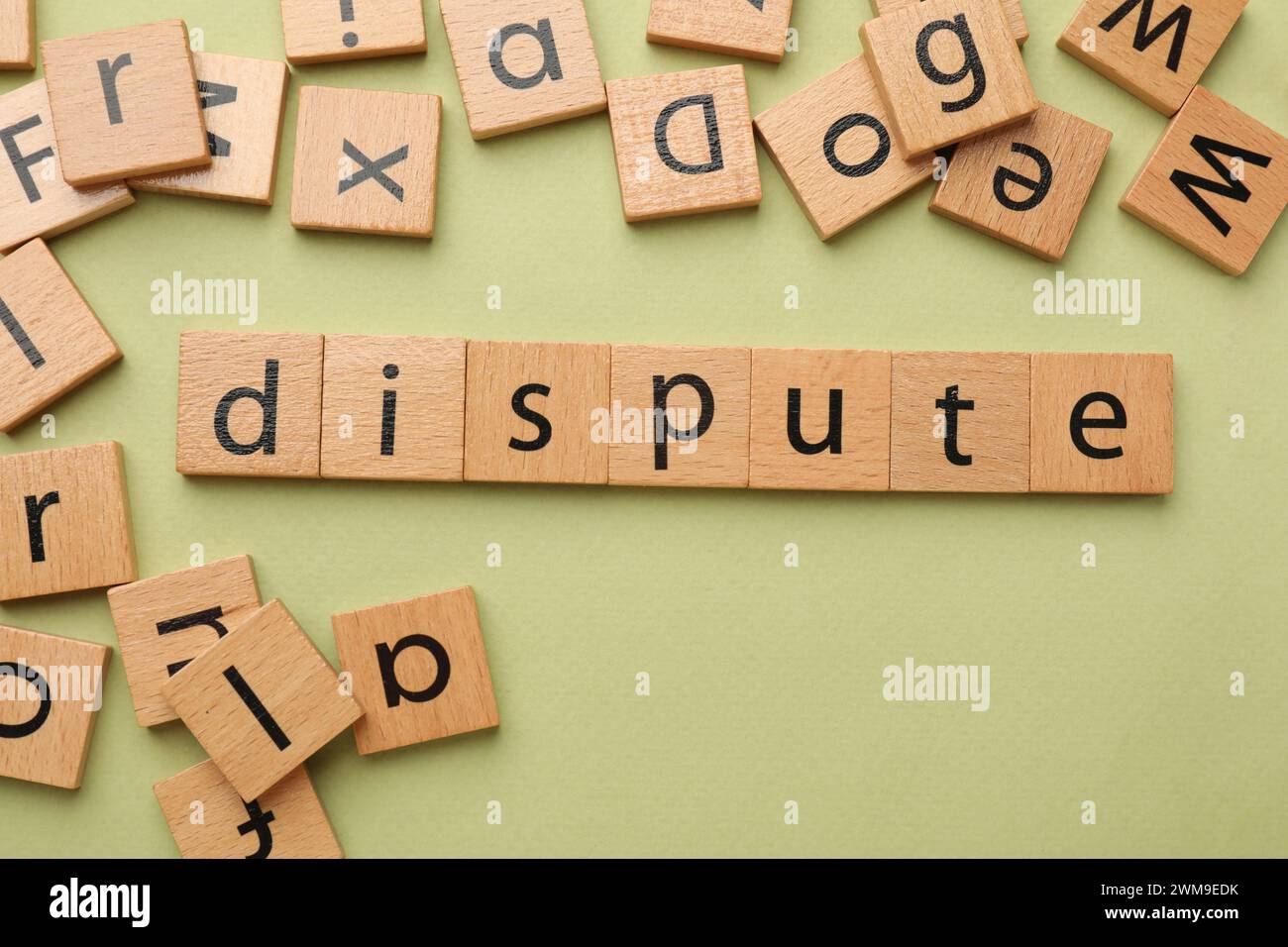 Squares with word Dispute on light green background, flat lay Stock ...