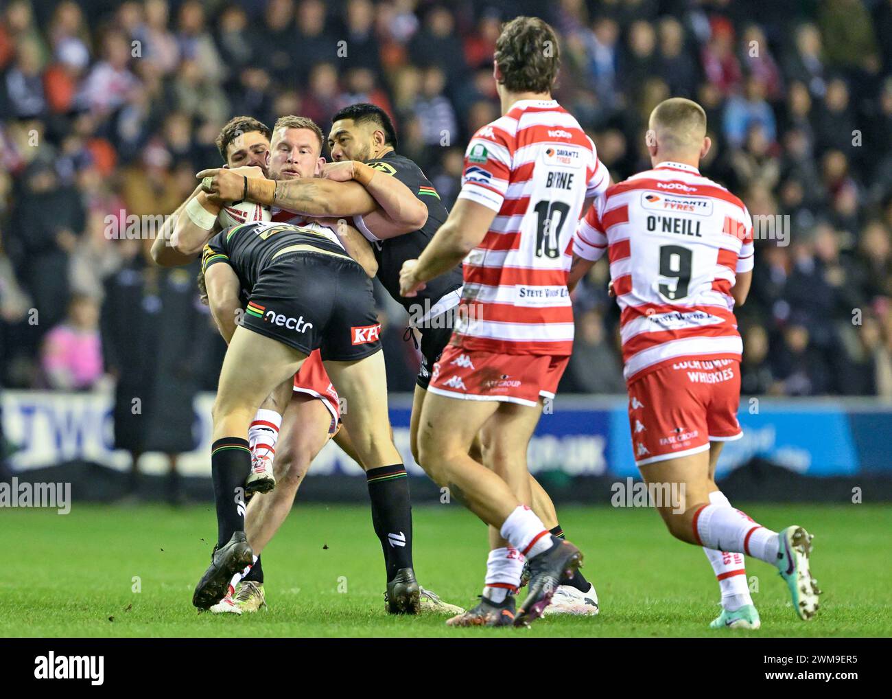 Mike Cooper of Wigan Warriors is tackled, during the 2024 World Club ...