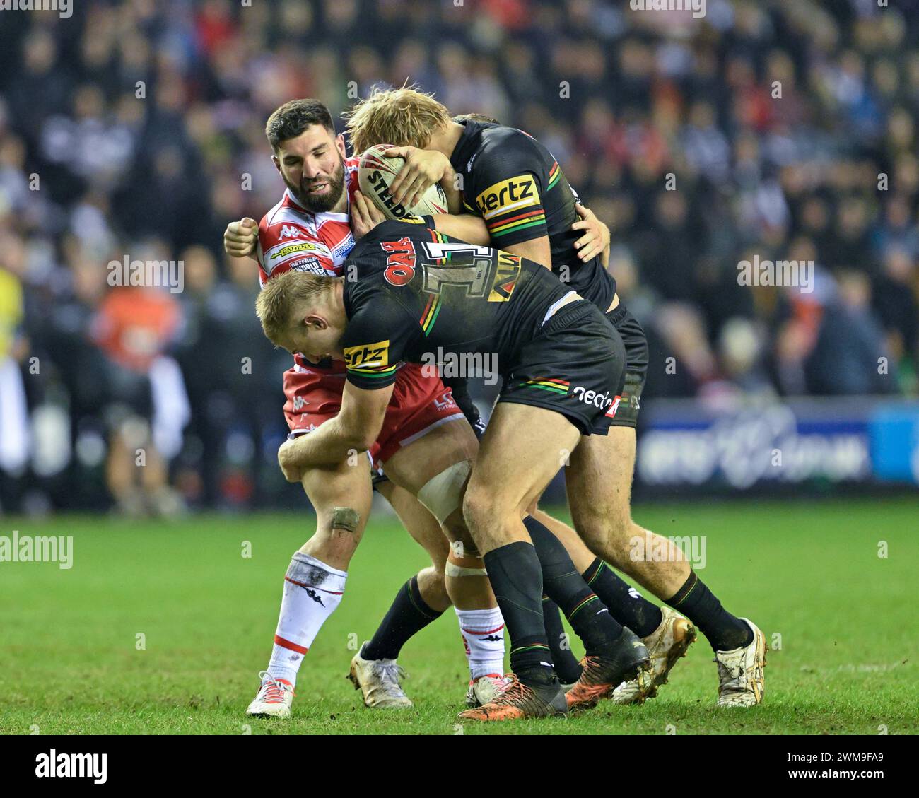 Abbas Miski of Wigan Warriors is tackled, during the 2024 World Club ...