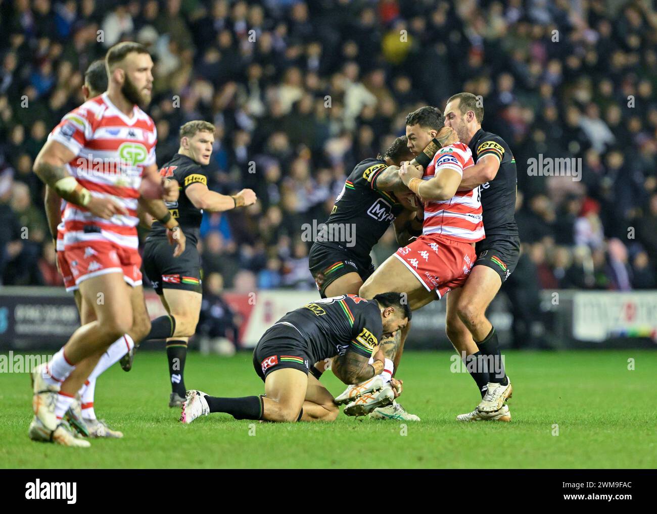 Tyler Dupree of Wigan Warriors is tackled, during the 2024 World Club ...