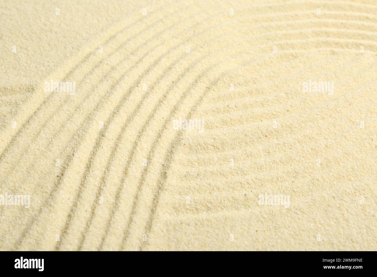 Zen rock garden. Wave pattern on beige sand Stock Photo - Alamy